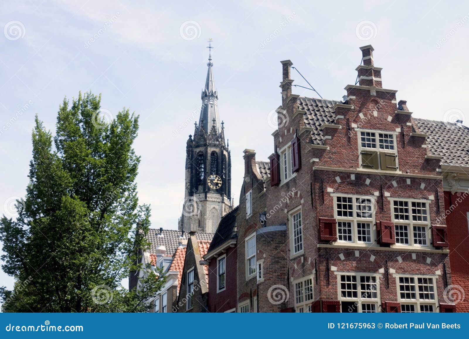 Church and houses in Delft stock image. Image of tower - 121675963