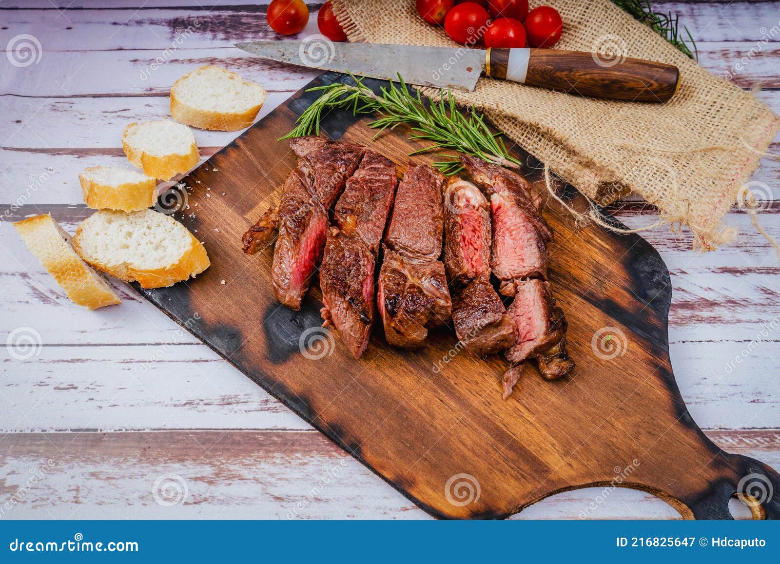 Churrasco of Meat Cut into Pieces on a Wooden Board in a Rustic Setting ...
