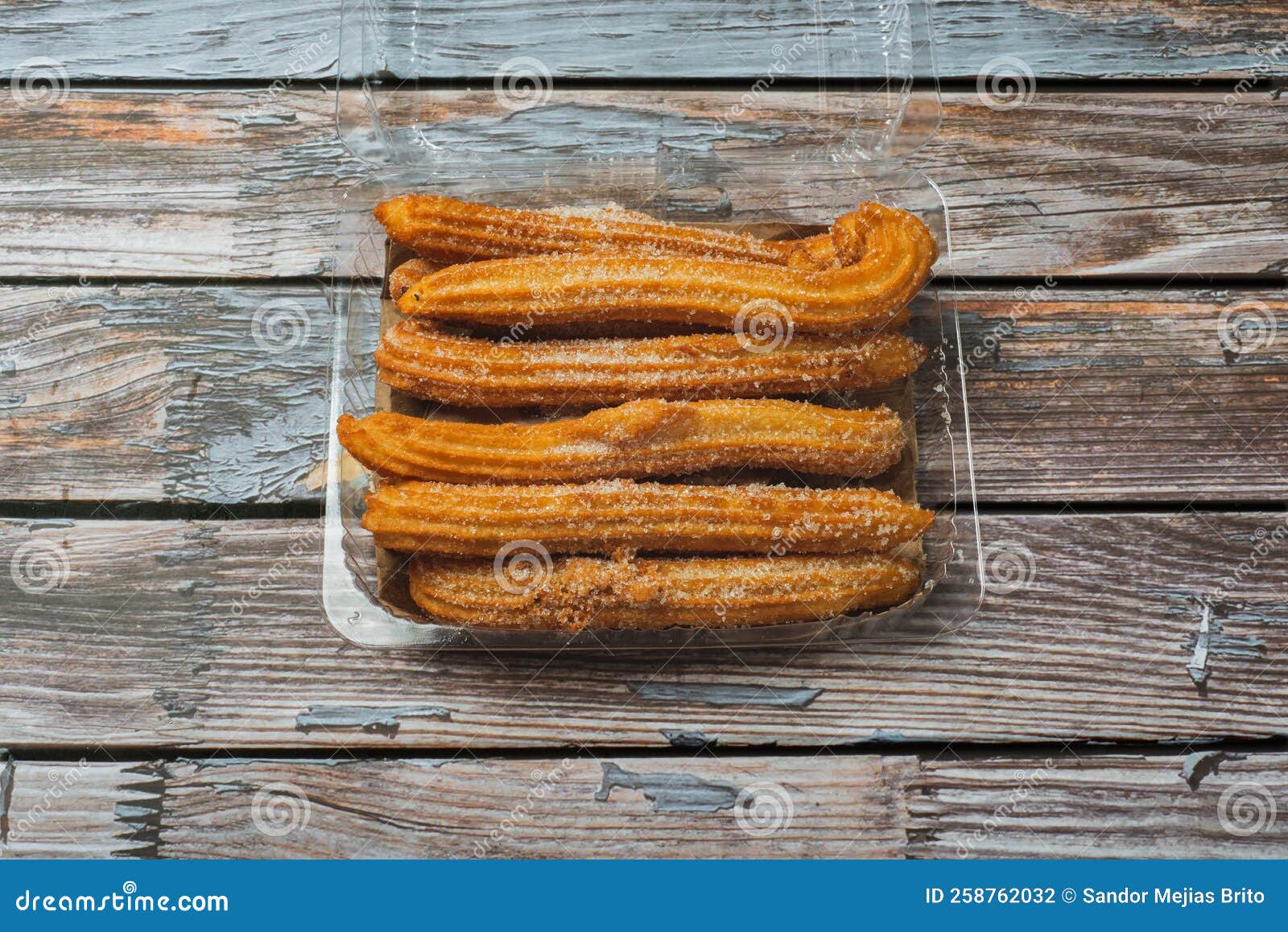 Churros in a Plastic Container on a Wooden Table Stock Photo - Image of ...