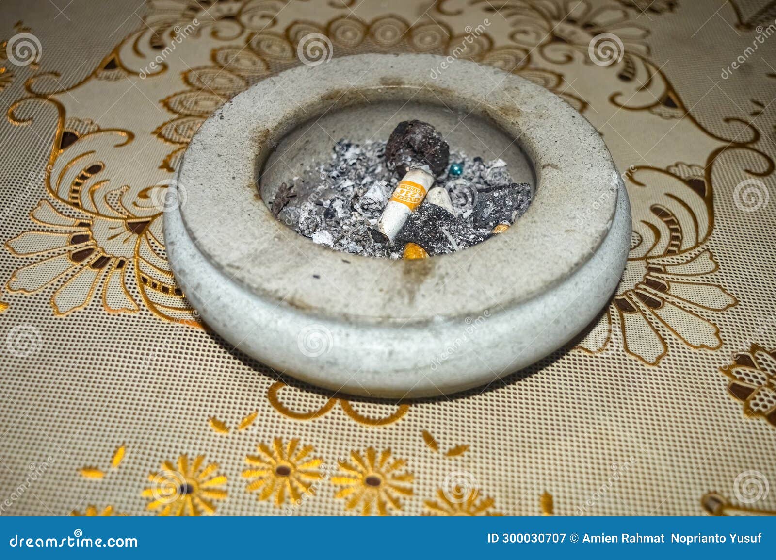 A Cigarette Ashtray with Remaining Cigarette Pieces and Cigarette Ash ...
