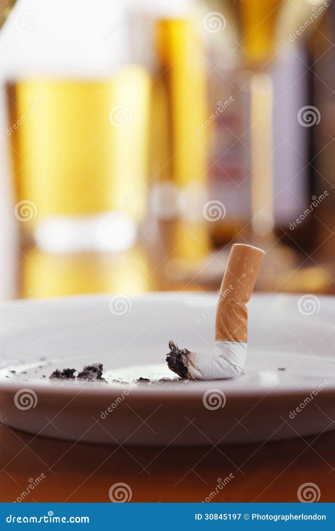 Cigarette in Ashtray on Table with Glasses of Beer Stock Image - Image ...