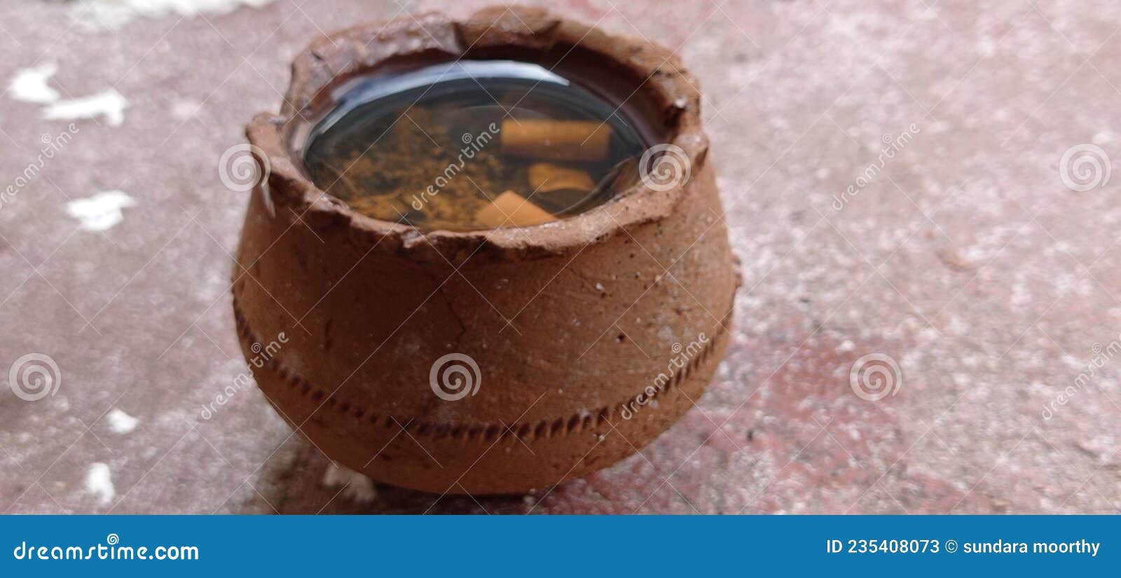 The Cigarette Buds on the Water with Pots Stock Image - Image of water ...