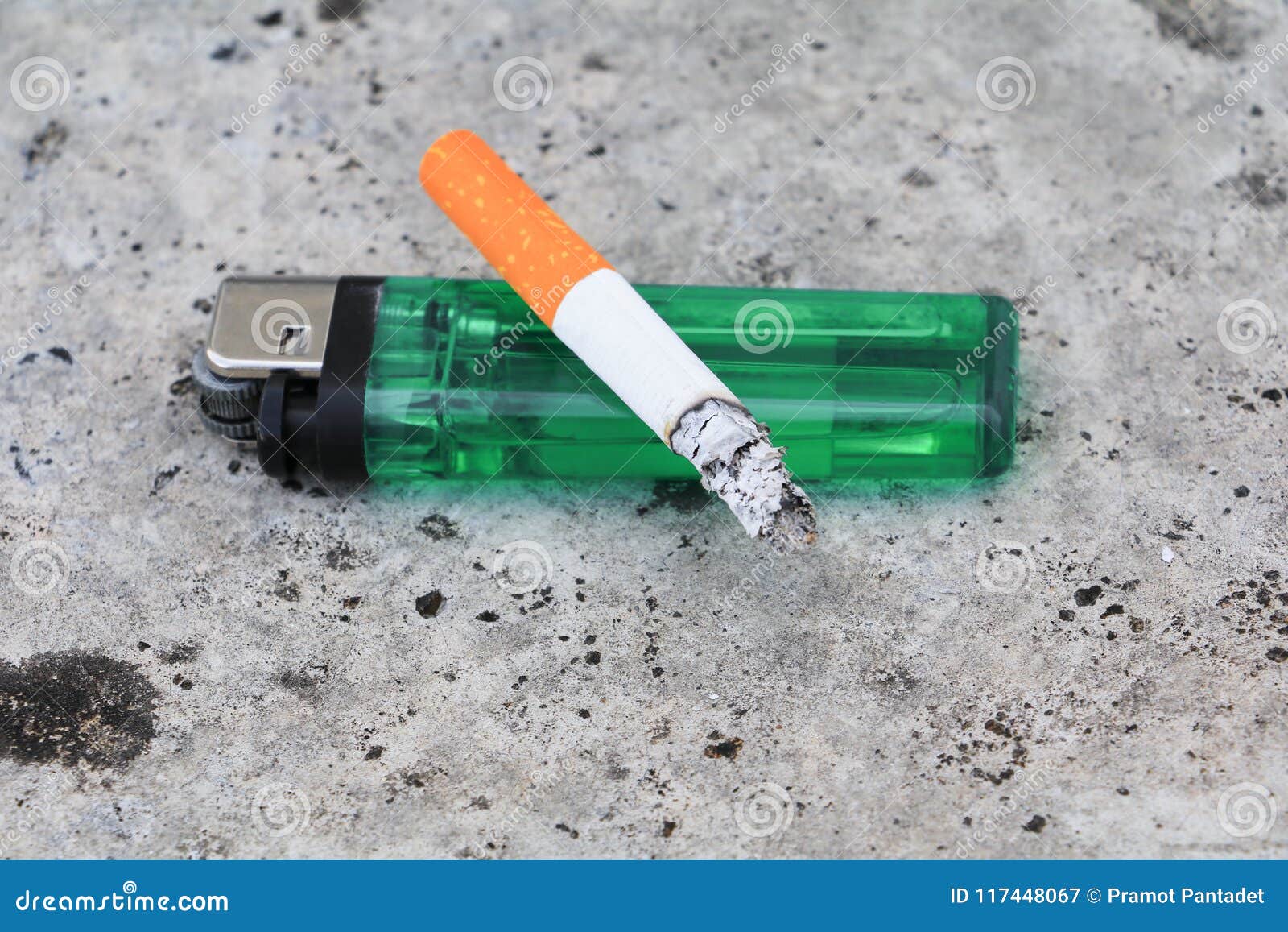 Cigarette Burn and Lighter on Floor Concrete Background. Concept Non ...
