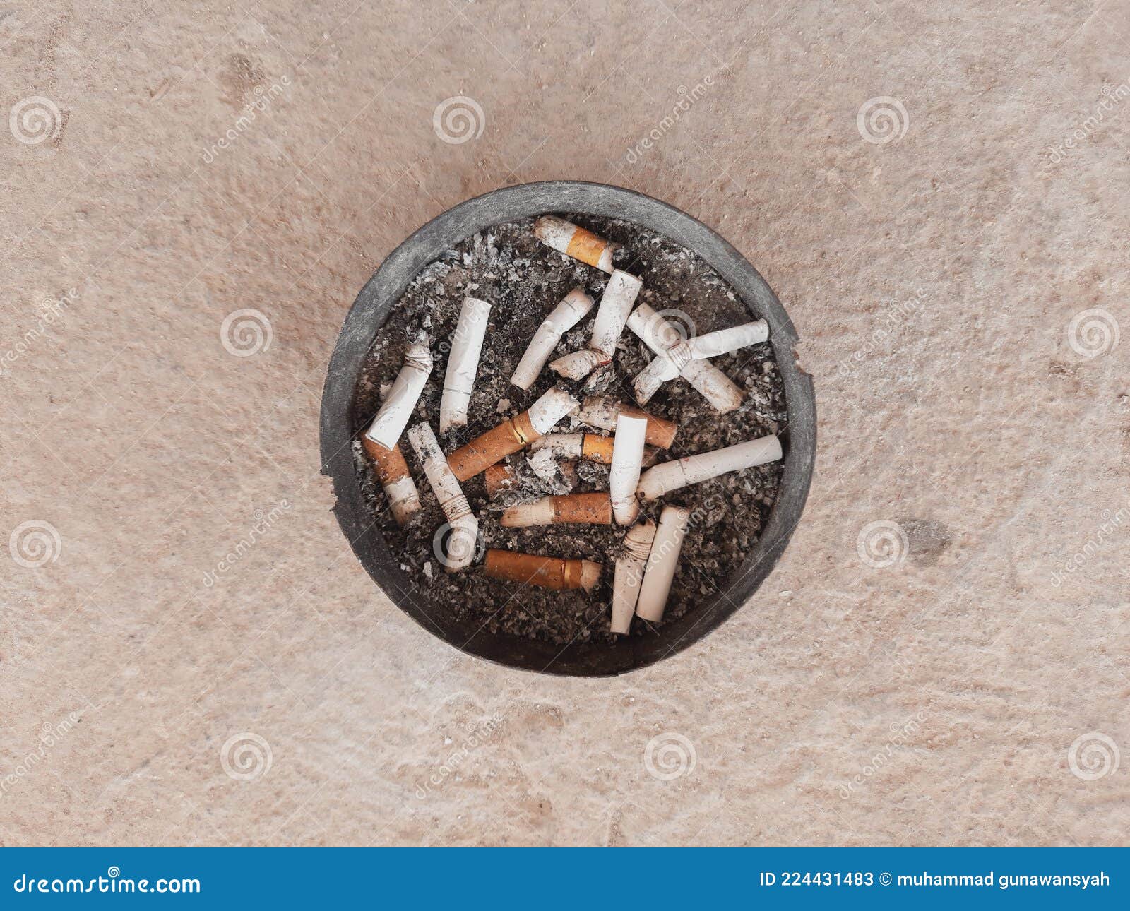 Cigarette Butts in an Iron Ashtray Placed on a Concrete Floor Stock ...