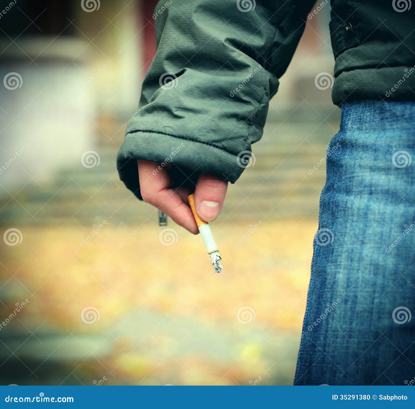 Cigarette in a Hand stock photo. Image of outside, street - 35291380