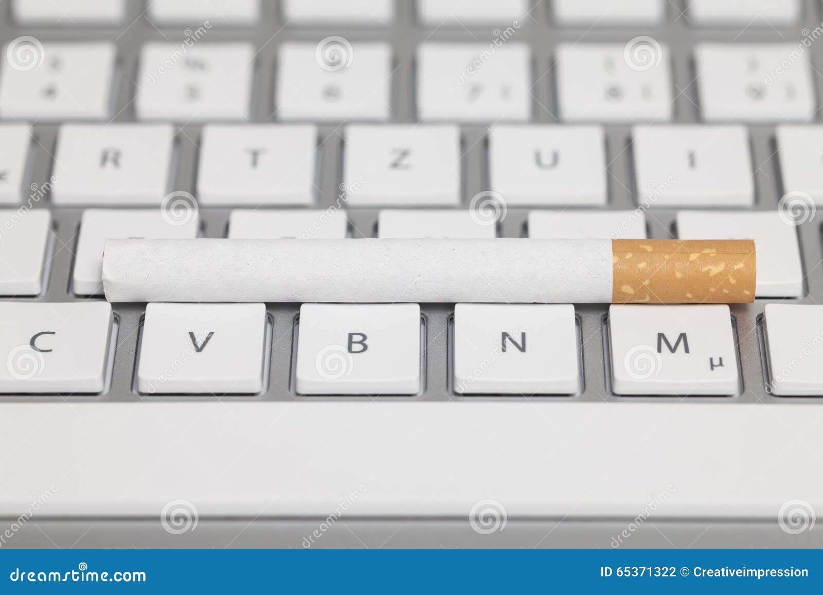 Cigarette on keyboard stock photo. Image of smoke, smoking - 65371322