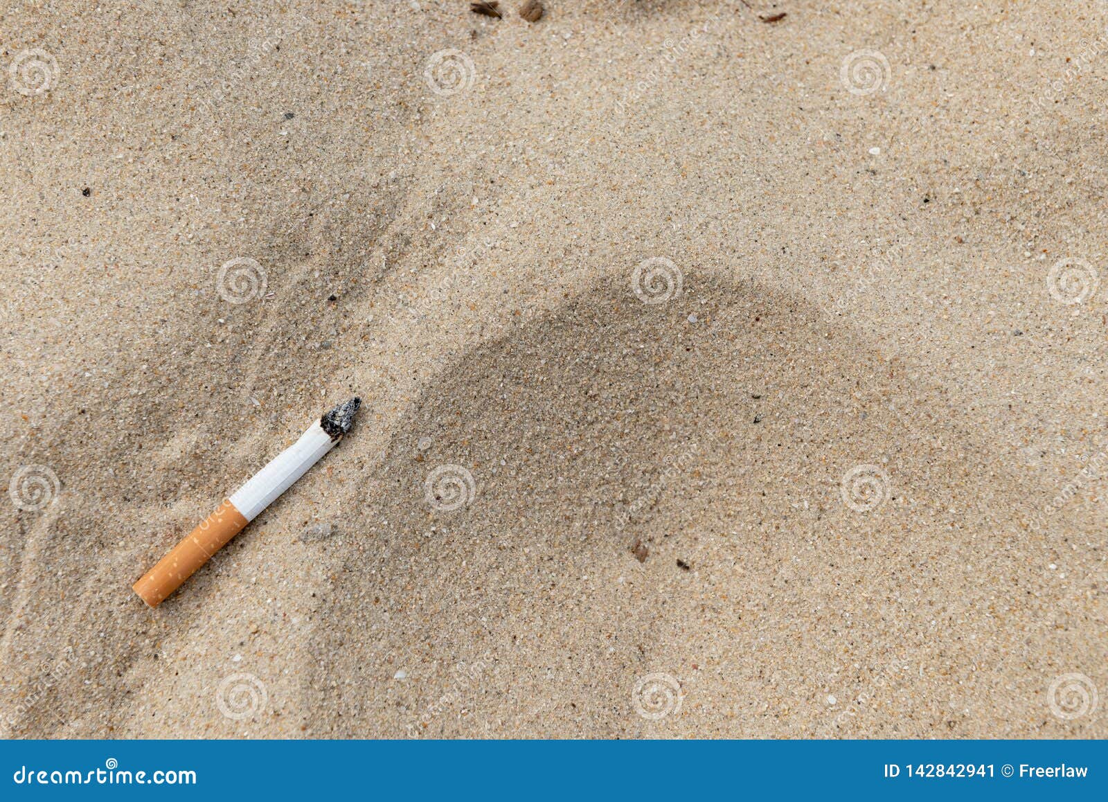 Cigarette on the sand stock image. Image of risk, smoke - 142842941