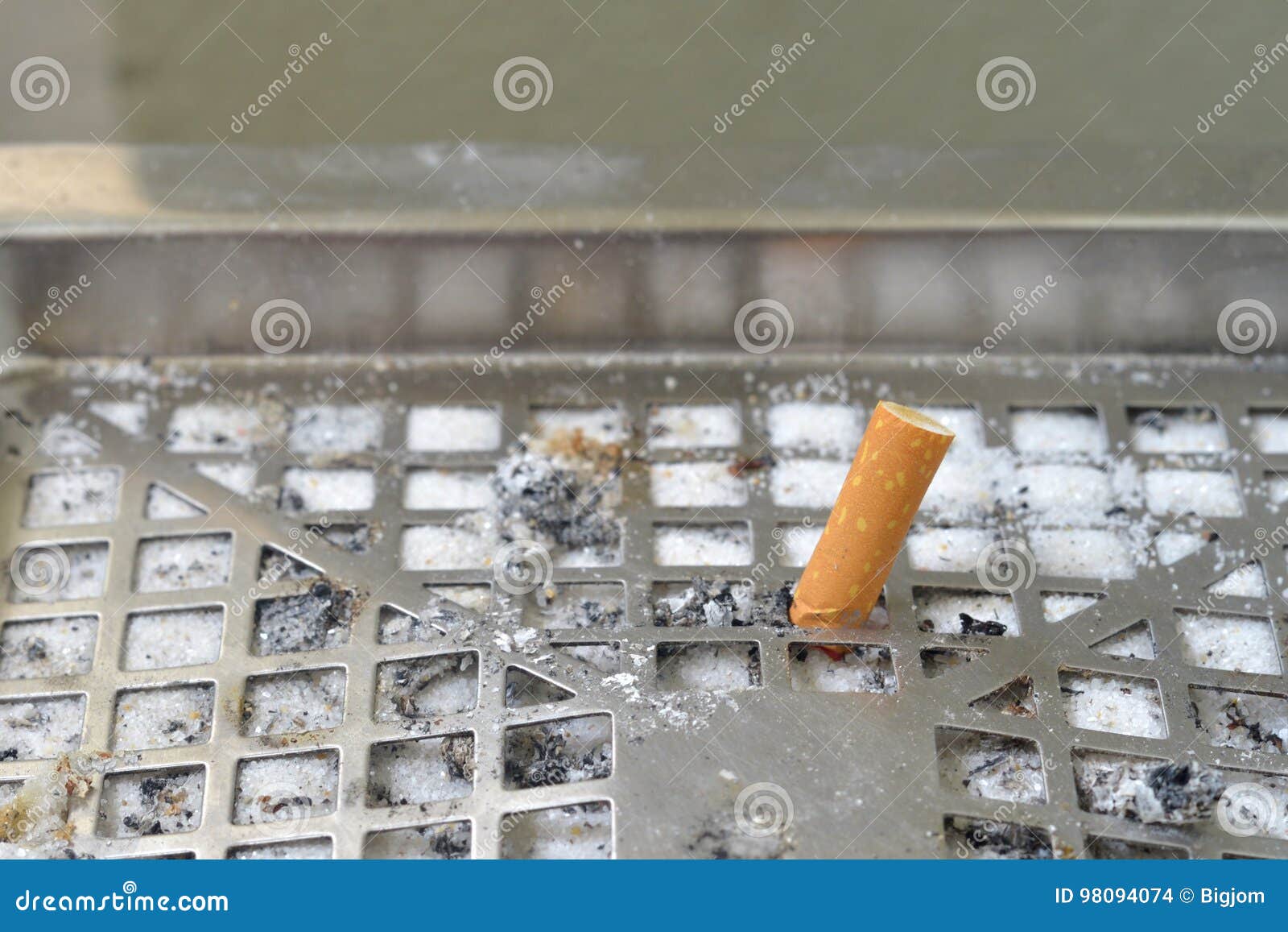 Cigarettes in sand ashtray stock photo. Image of rudeness - 98094074
