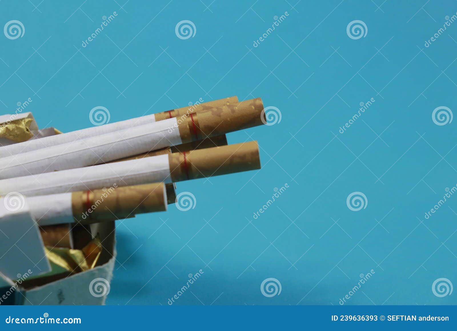 Cigarettes Coming Out of the Pack on a Blue Background Stock Image ...