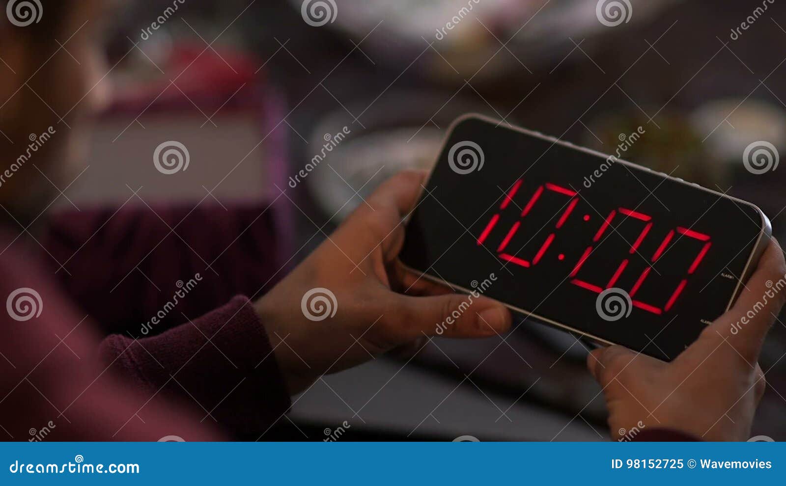 Cinemagraph of Man Holding a Digital Clock and Looking at the Time ...