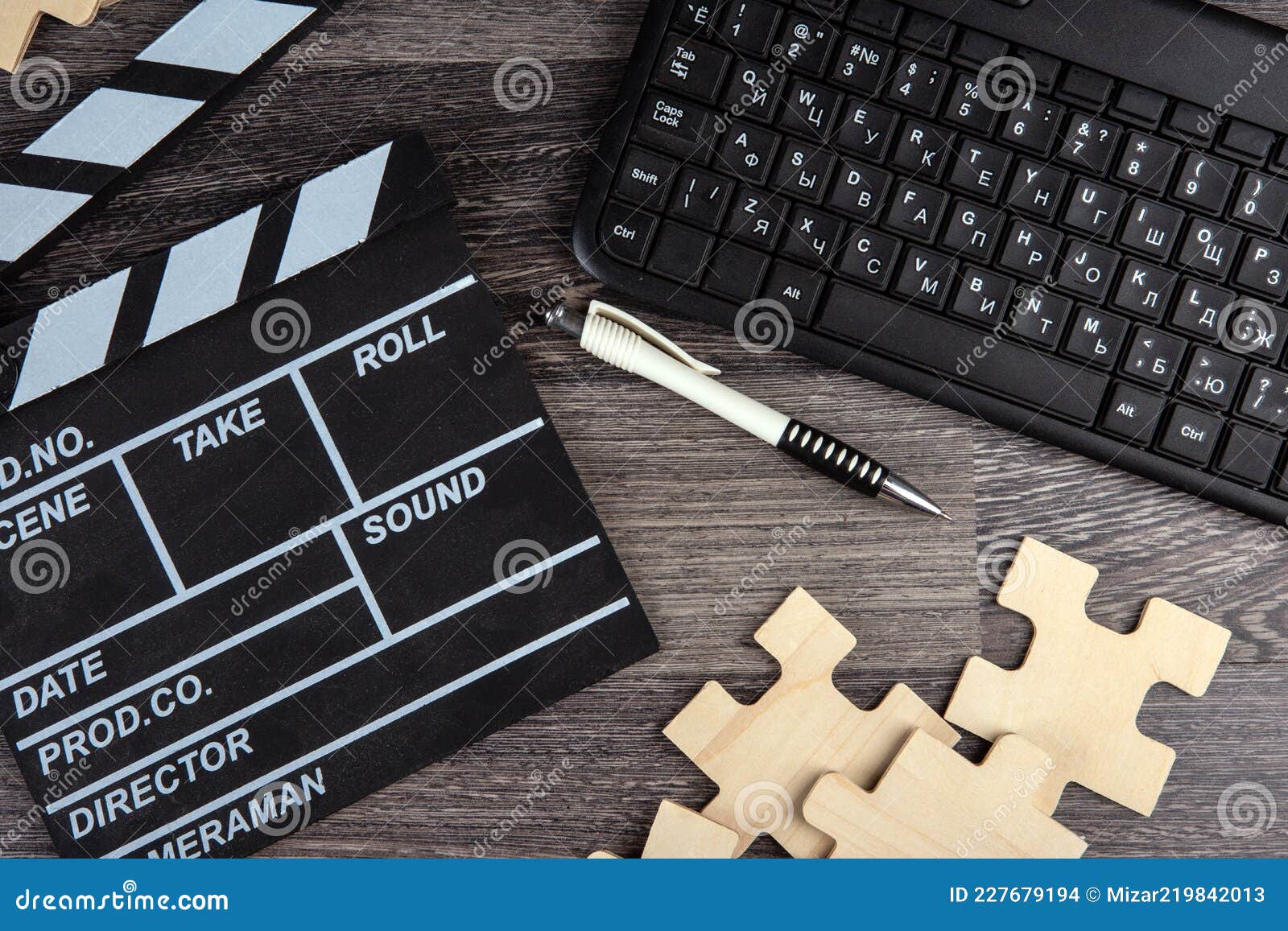Cinematic Clapper, Pc Keyboard, Pen and Puzzle Pieces on a Table Stock ...