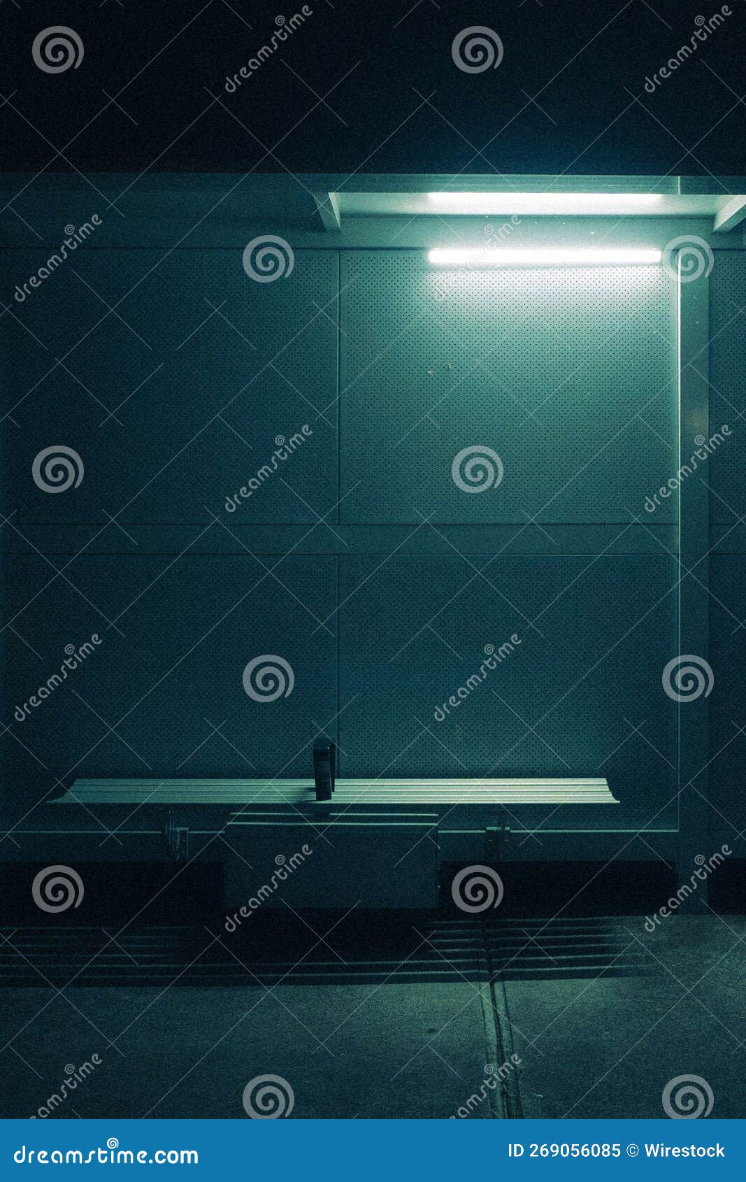 Cinematic Vertical Shot of an Empty Bus Stop at Night with a Light on ...