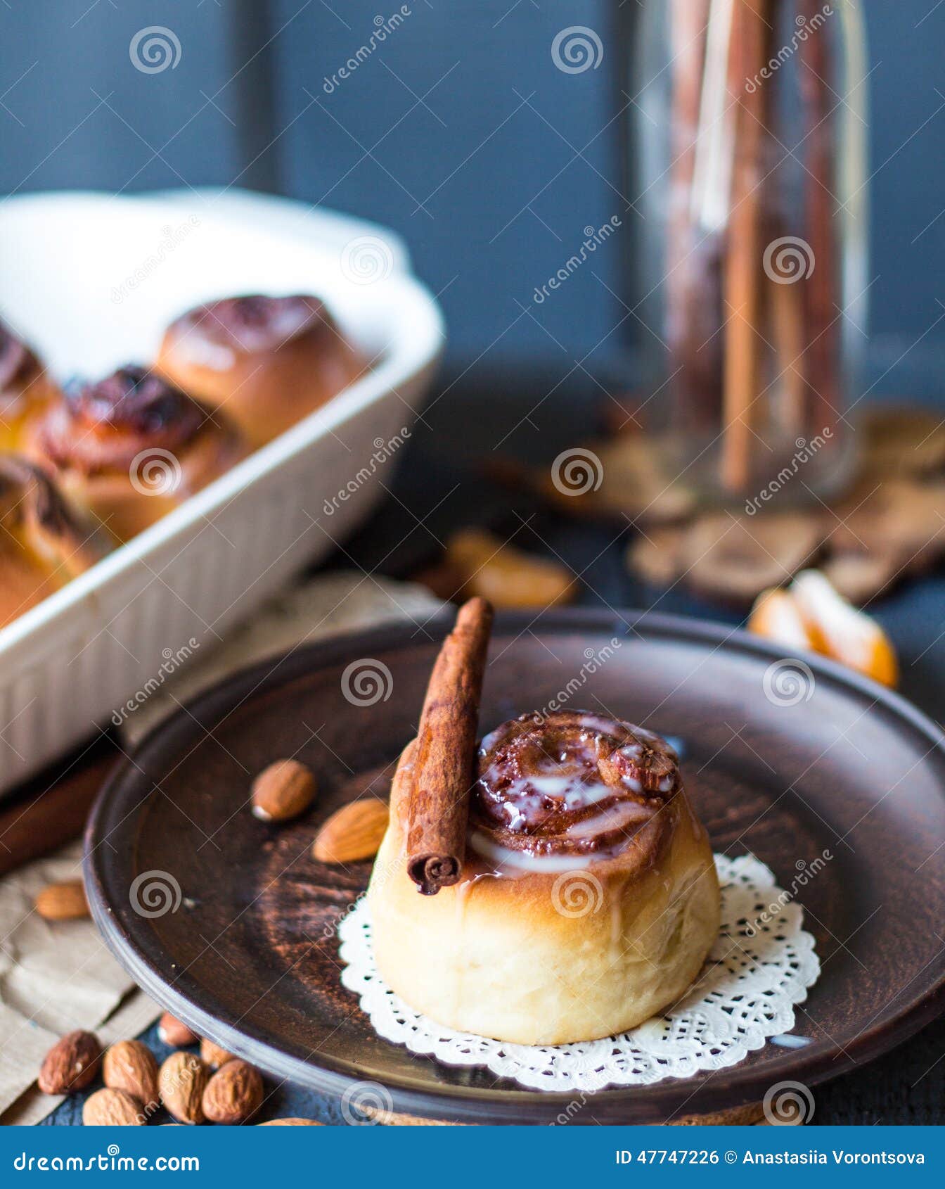 Cinnabon Cinnamon Rolls, Almonds and Mandarins on a Dark Plate Stock ...