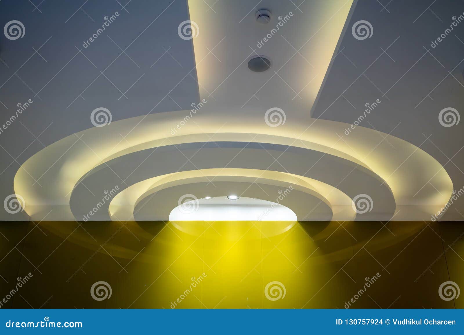 Circle Shapes Ceiling with Lighting Against Yellow Wall. Interior ...