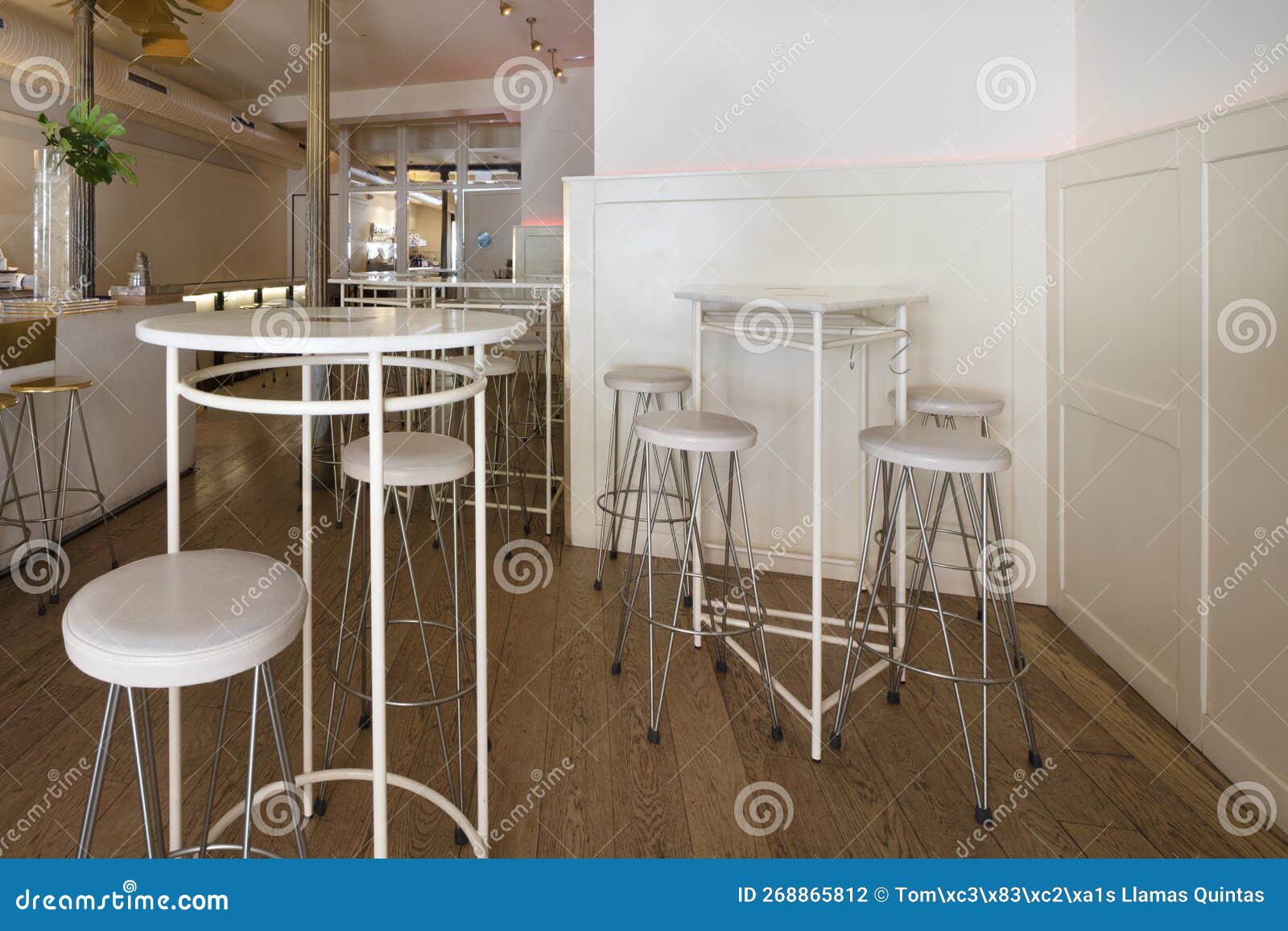 Circular High Tables with Matching White Upholstered Stools in a ...