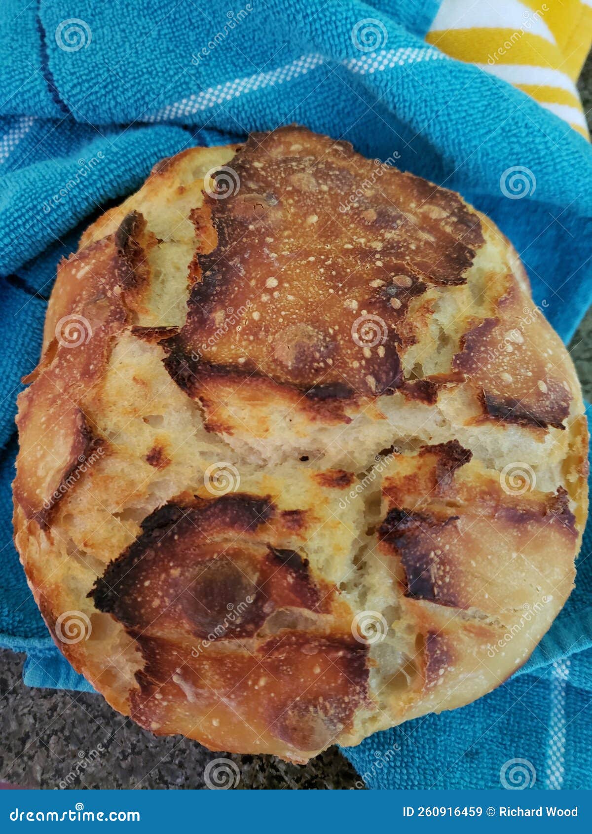 Circular Loaf of Bread Sitting on Colorful Towels Stock Image - Image ...
