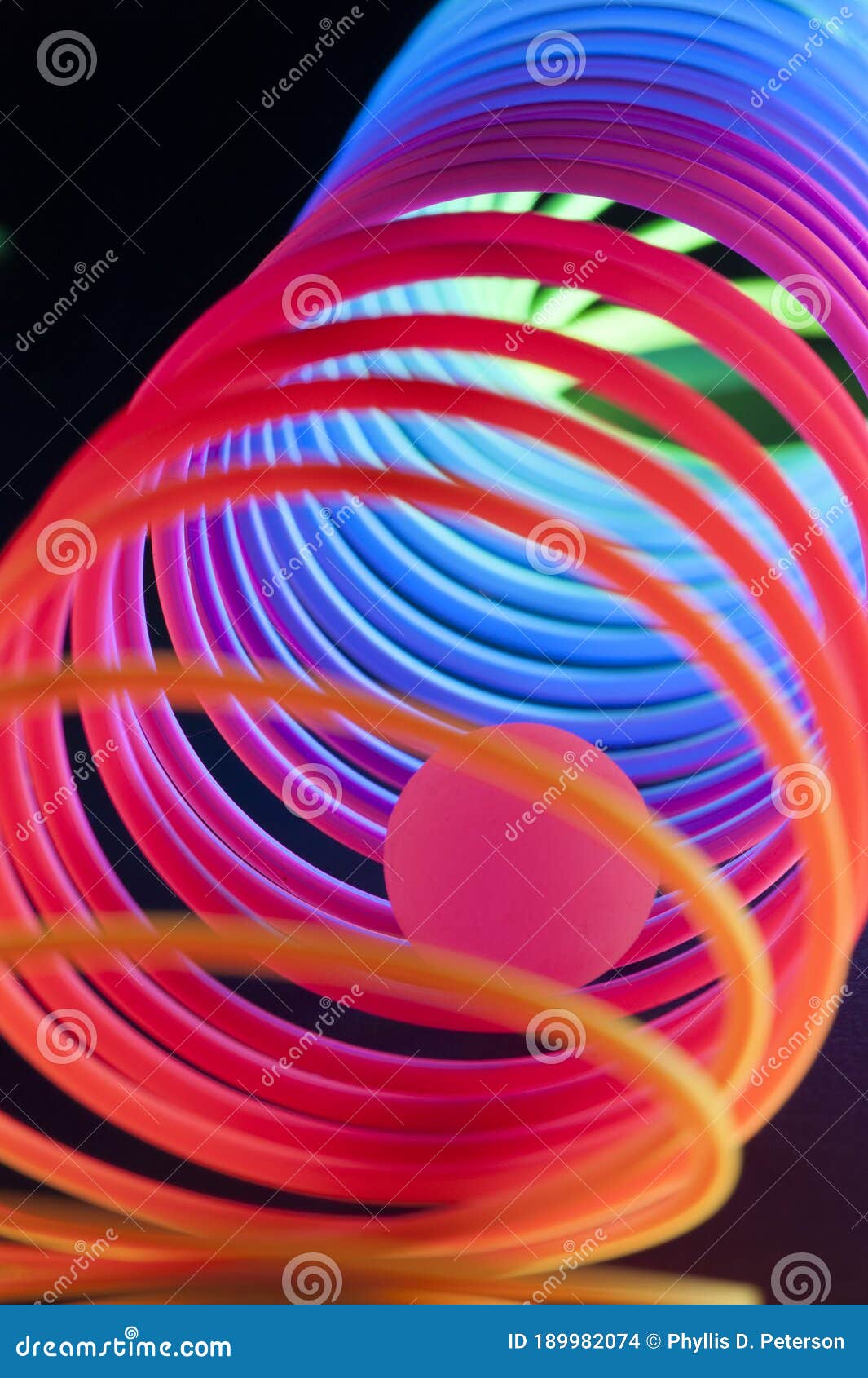 Circular Objects are Lit with Fluorescent Colors Against a Deep Blue ...