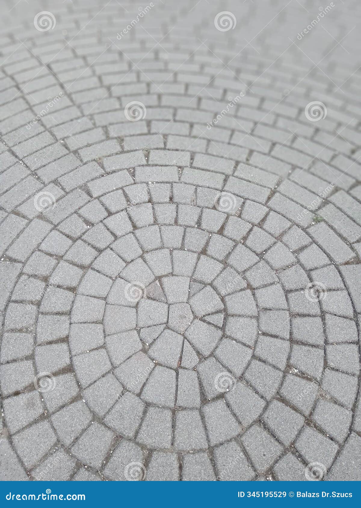 Circular Patterned Cobblestone Pavement in a Grey Urban Setting Creates ...