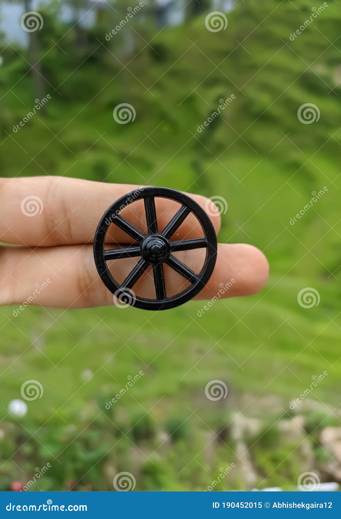 A Circular Wheel between Fingers. Stock Image - Image of lawn, glasses ...