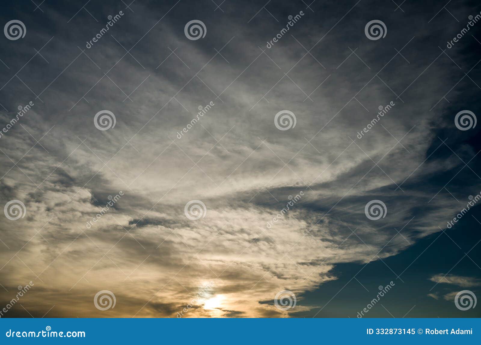 Cirrus Clouds at Sunset in the Dark Blue Sky. with the Hidden Sun Stock ...