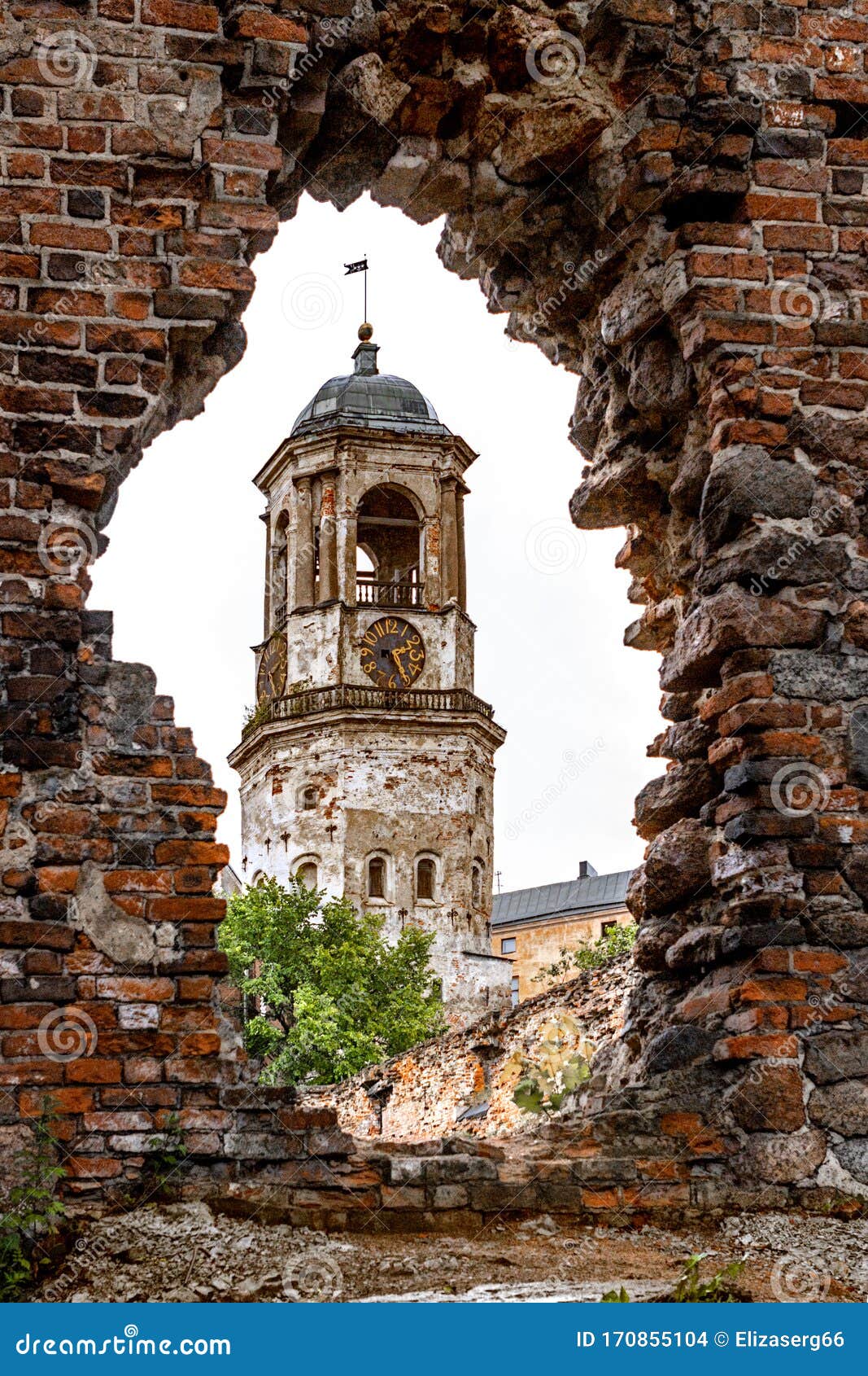 City Old Clock Tower in the Opening of the Ruined Wall Stock Photo ...