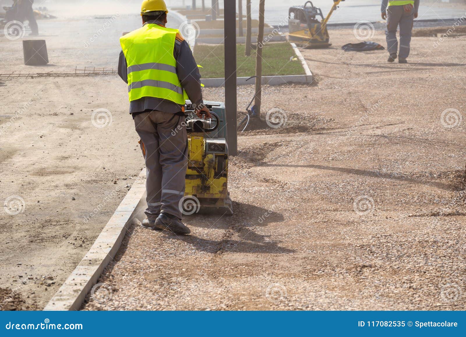 Worker Compacting Soil With Vibration Compaction Machine During ...
