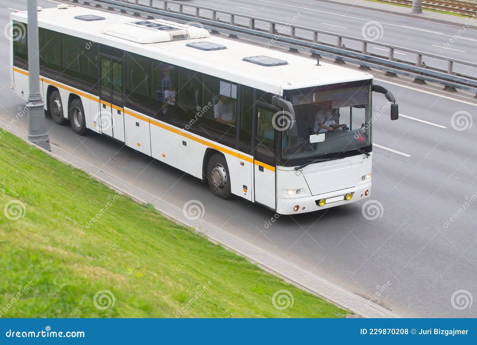 City Shuttle Bus Carries Passengers Down the Street Stock Photo - Image ...