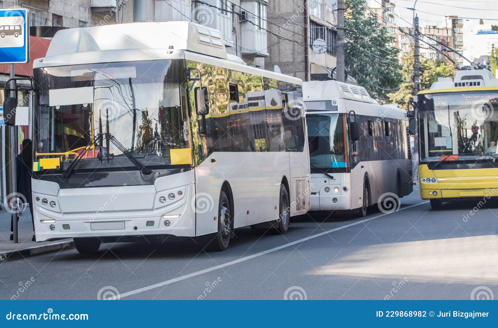 City Shuttle Buses at a Stop on the Street Stock Photo - Image of road ...