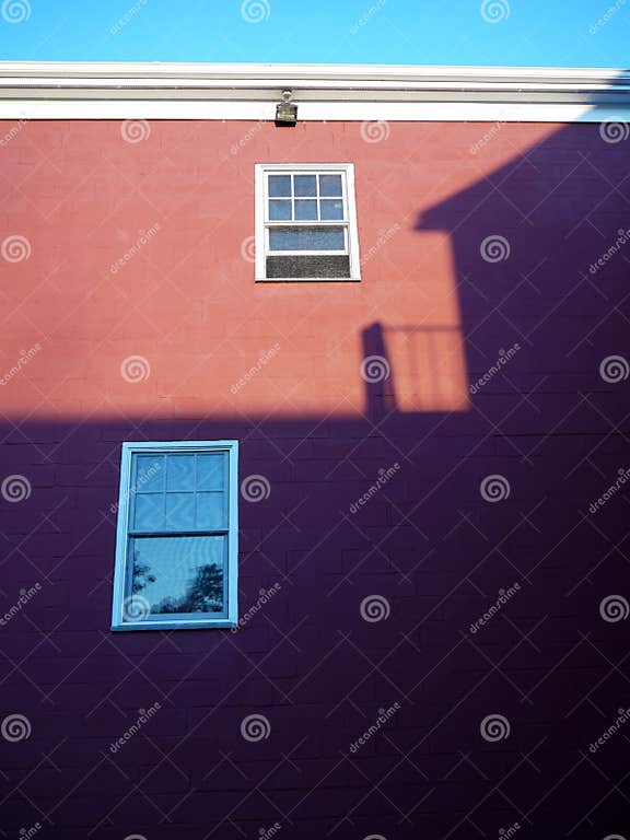 City: Sunset Building Shadow on Red Wall Stock Image - Image of sunny ...