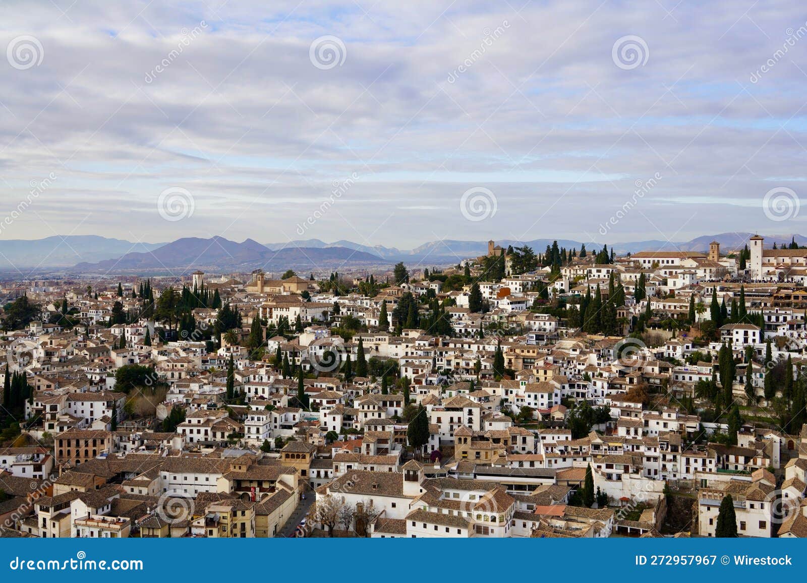 Cityscape with an Array of White Buildings Surrounded by Lush Mountains ...