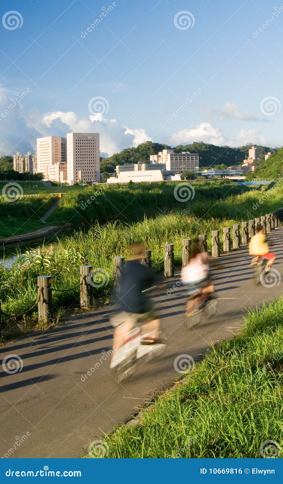 Cityscape of Bicycle Driver at Riverbank Stock Photo - Image of path ...