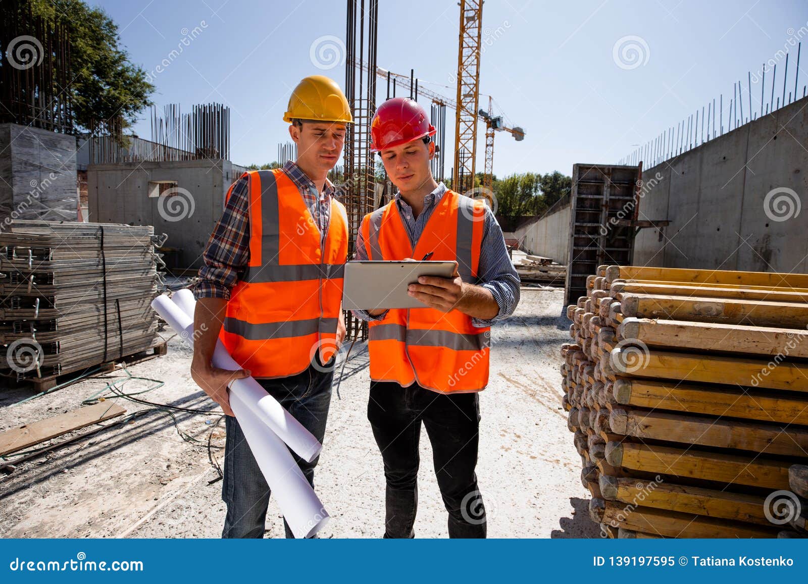 Civil Architect and Construction Manager Dressed in Orange Work Vests ...