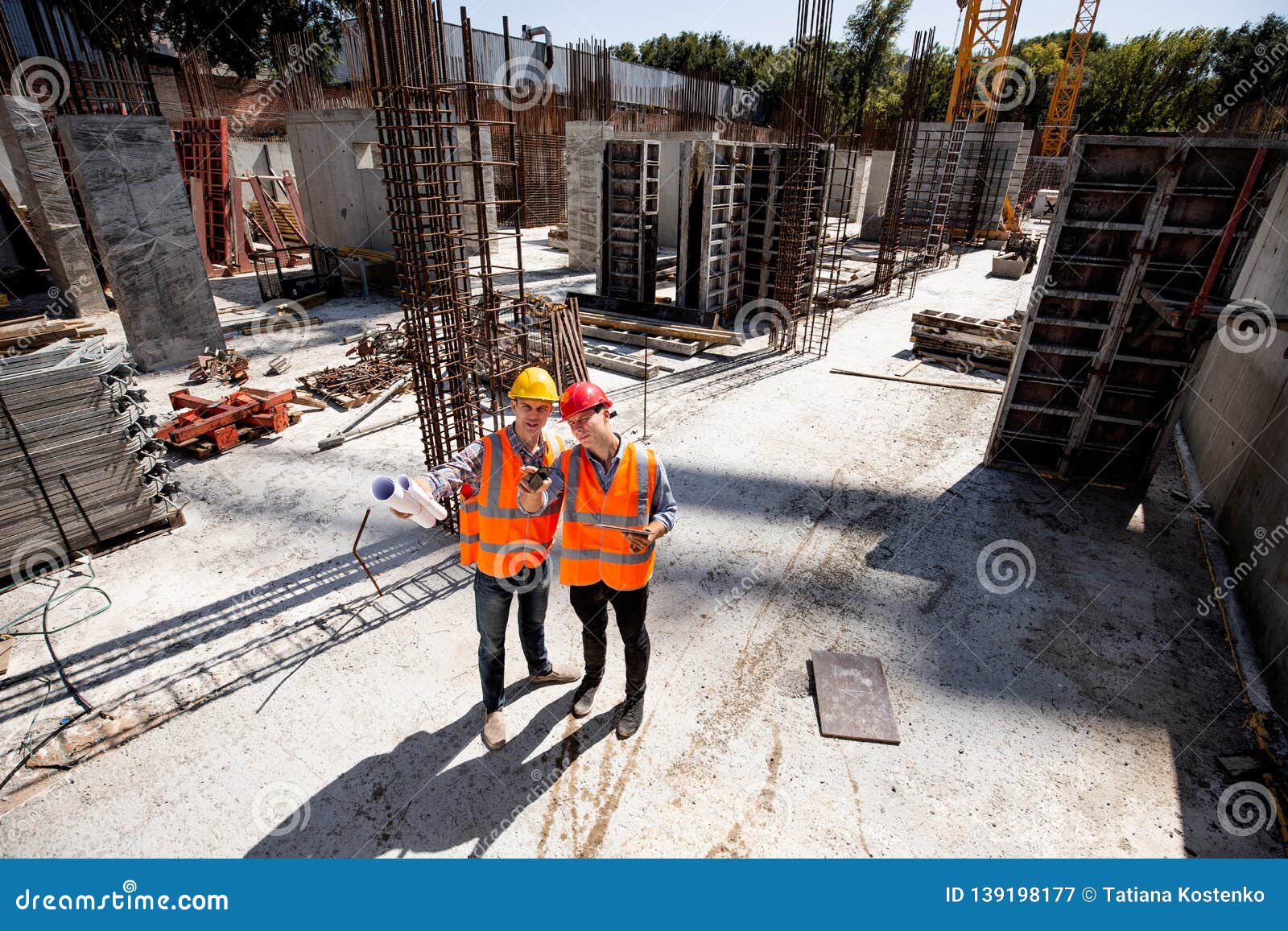 Civil Engineer and Architect Dressed in Orange Work Vests and Hard Bats ...