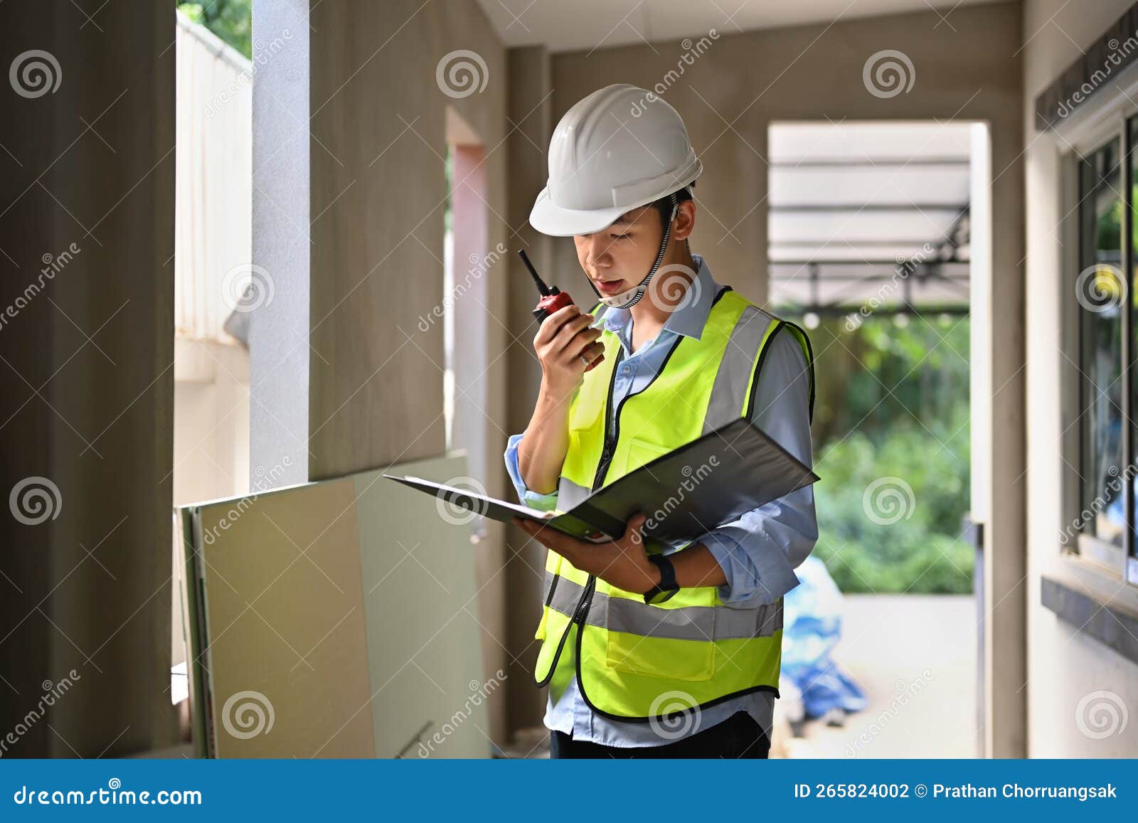 Civil Engineer Communicating with Walkie Talkie and Working with ...