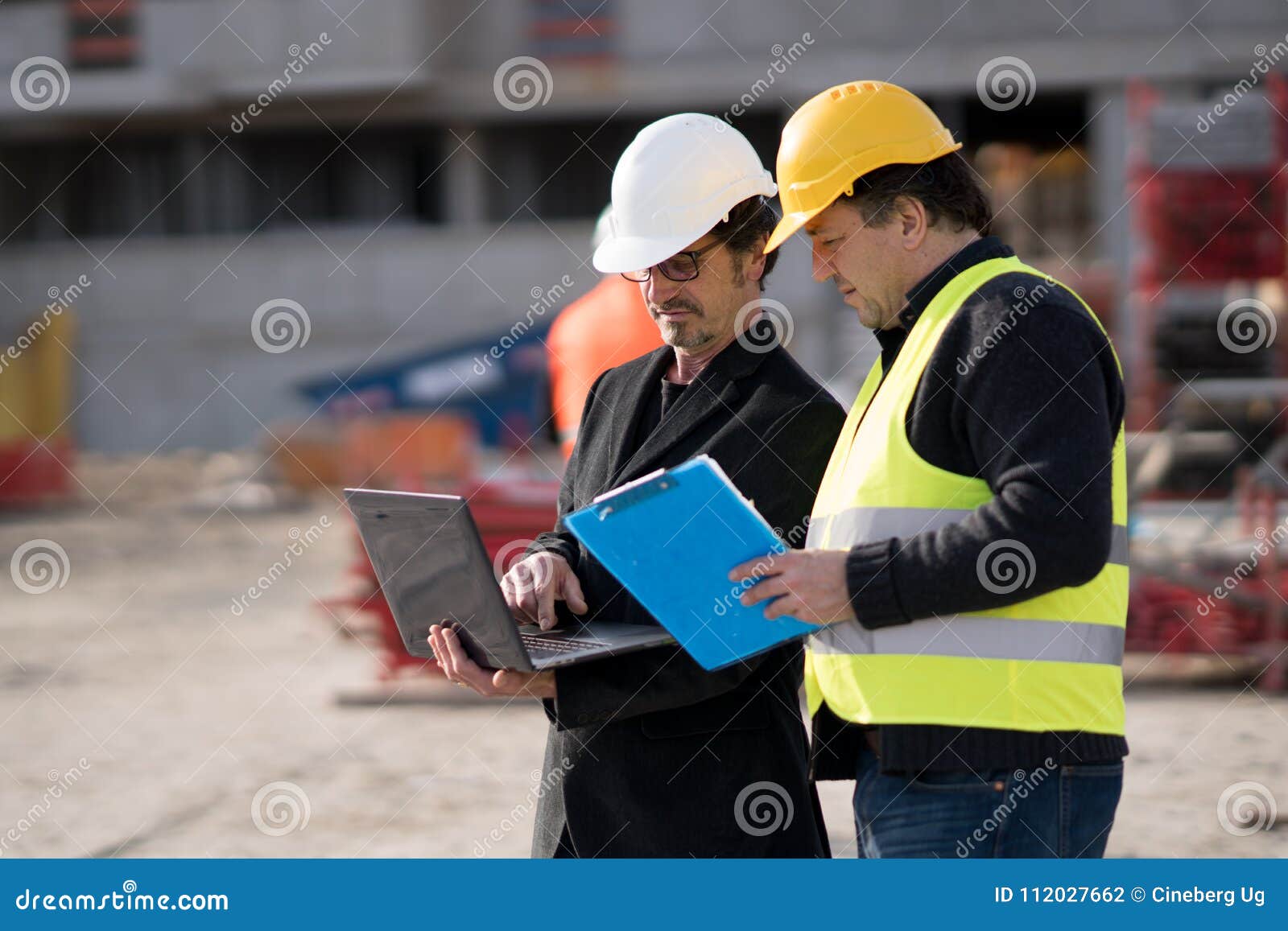 Civil Engineer Giving Instructions To Construction Worker Stock Photo ...