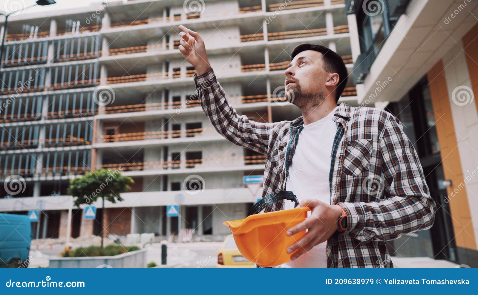 Civil Engineer Giving Instructions To Construction Workers on ...