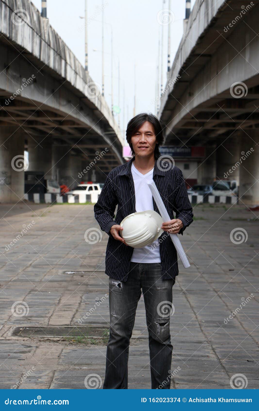 Civil Engineer Man Standing with Helmet and Project Drafts while in ...