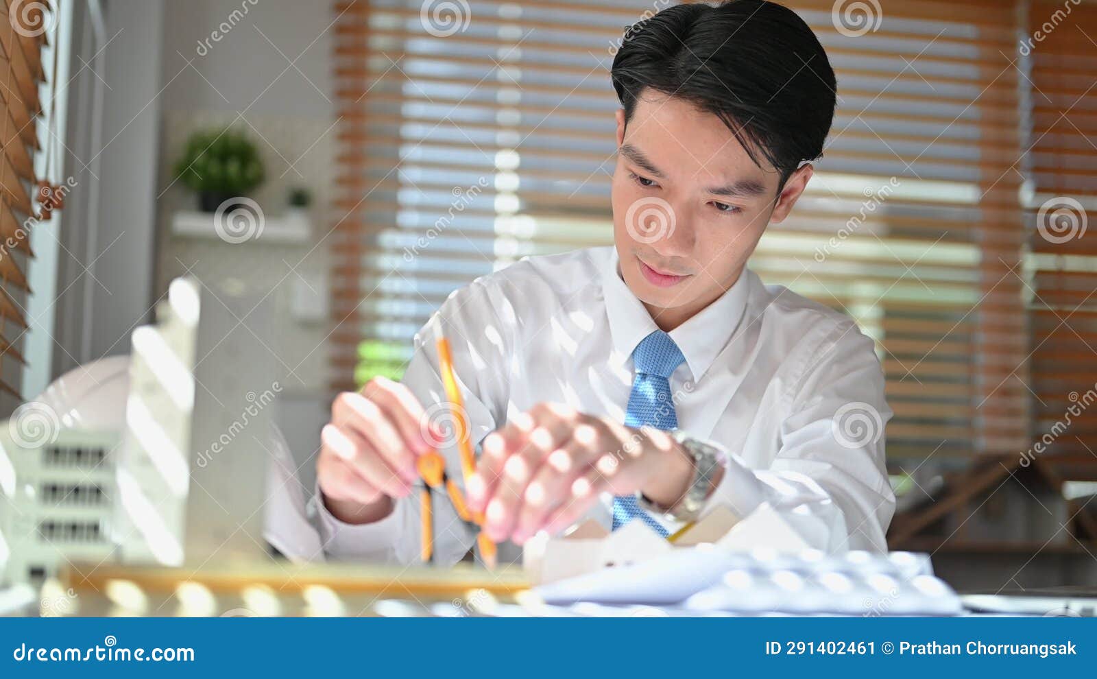 Civil Engineer Man Using Compass To Measuring Scale on a Blueprint ...