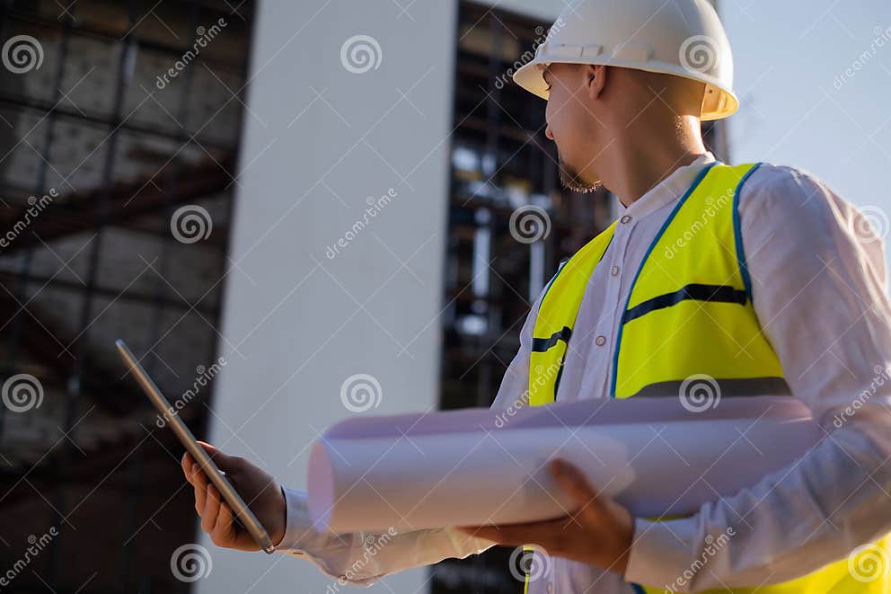 Civil Engineer Using a Tablet, Planning a Project, Builds a Modern ...