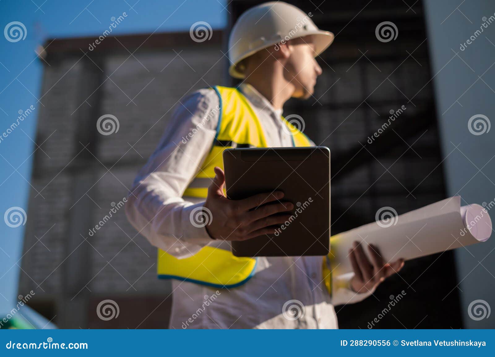 Civil Engineer Using a Tablet, Planning a Project, Builds a Modern ...