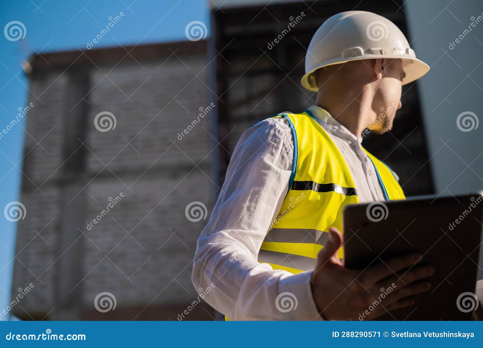 Civil Engineer Using a Tablet, Planning a Project, Builds a Modern ...
