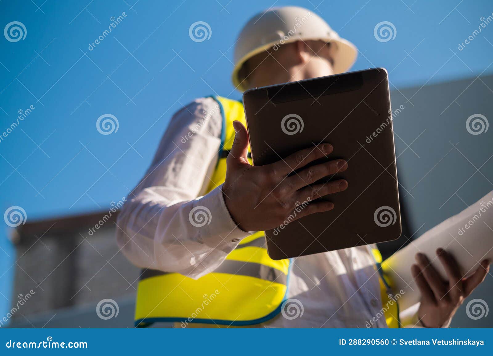 Civil Engineer Using a Tablet, Planning a Project, Builds a Modern ...