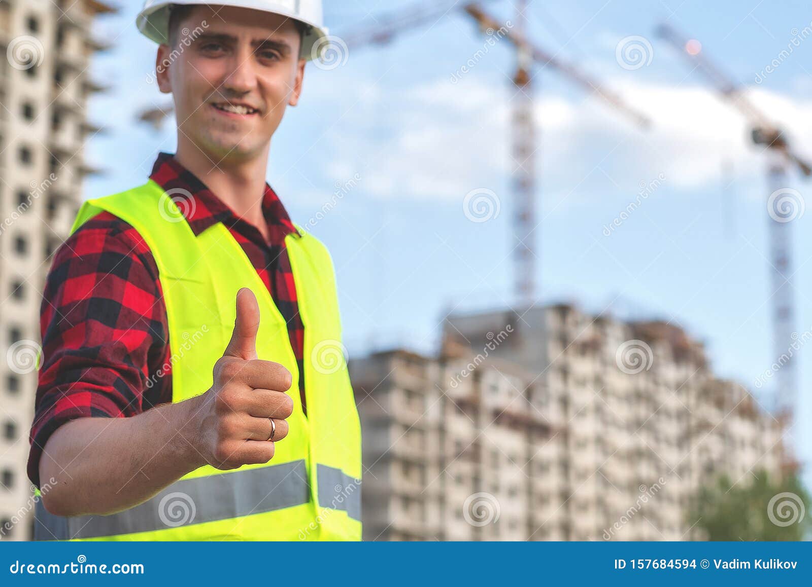 Civil Engineer in a White Helmet on the Background of Construction ...
