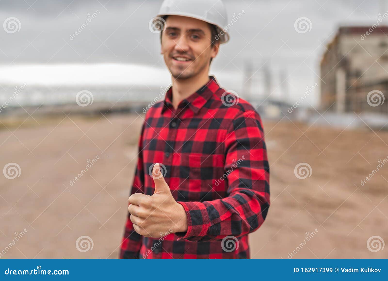 Civil Engineer in a White Helmet on the Background of Construction ...