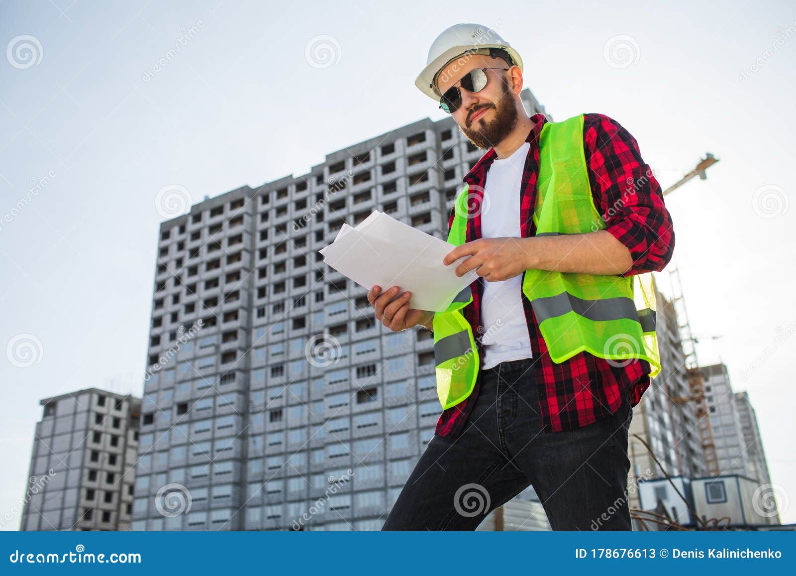 Civil Engineer in a White Helmet on the Background of Houses Under ...