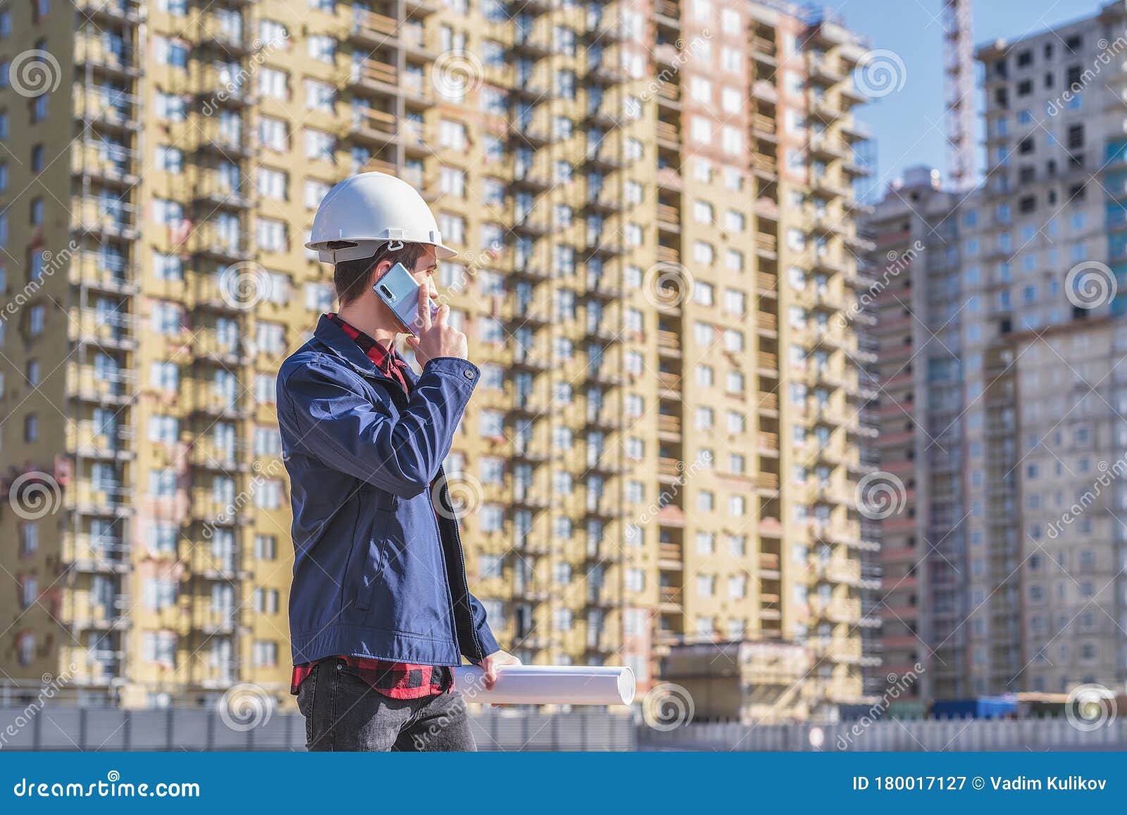Civil Engineer in a White Helmet with Documents in His Hands Talking on ...