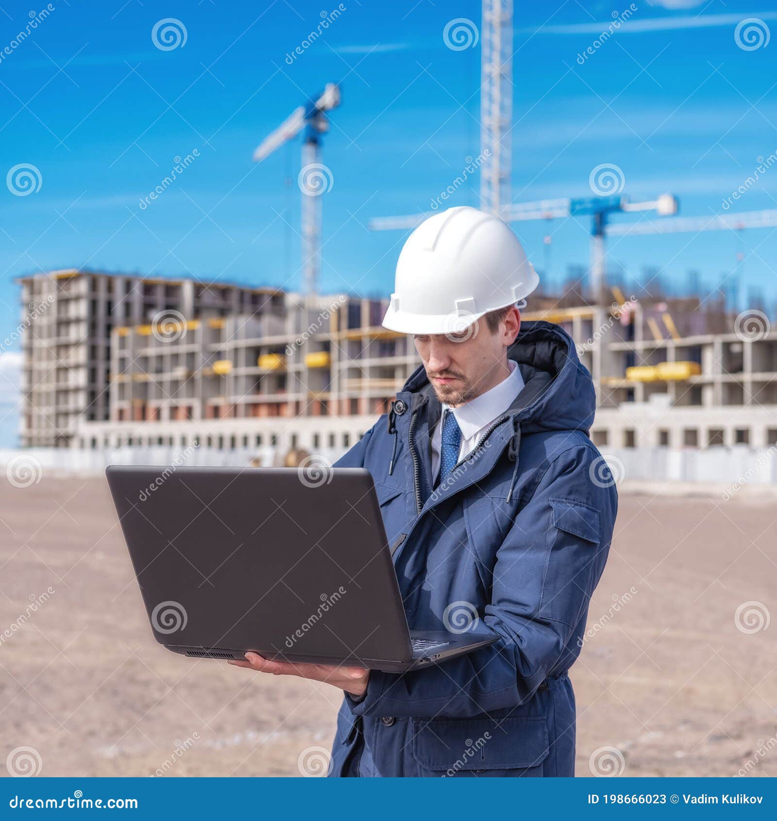 Civil Engineer in a White Helmet Looking Documents on the Background of ...