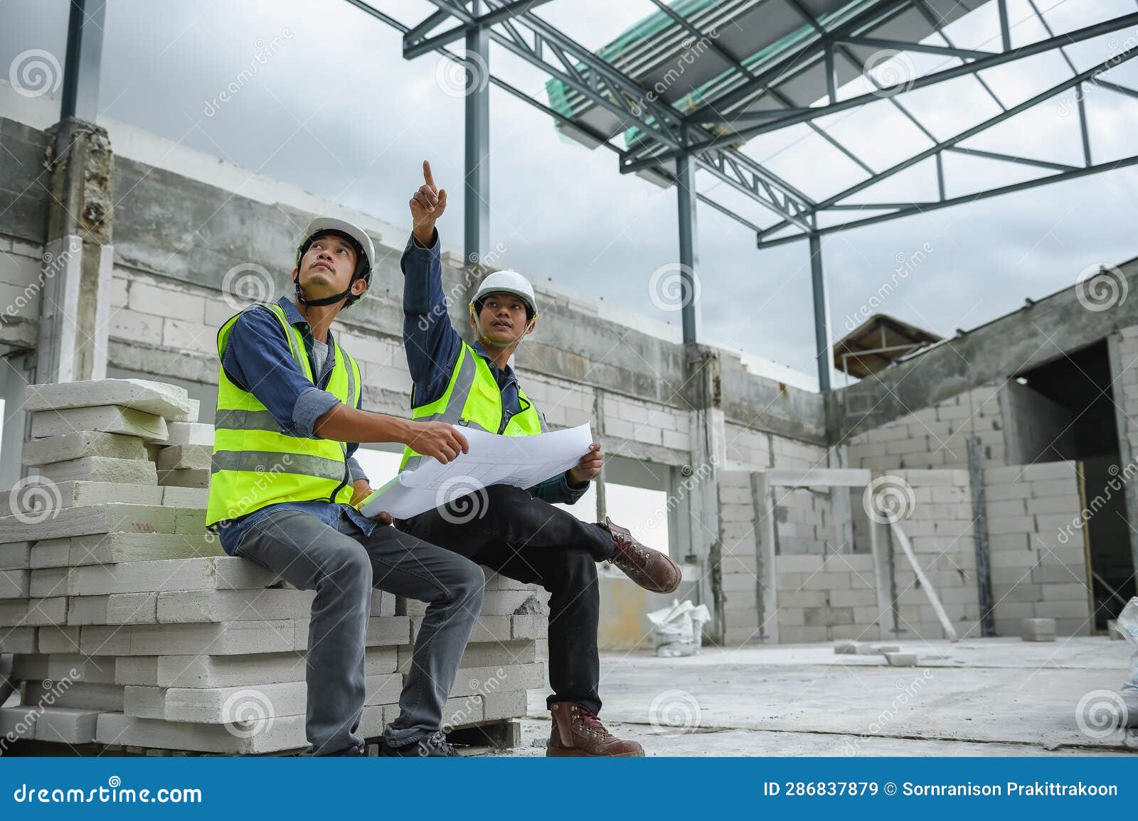 Civil Engineers Discuss with Foreman or Builder while Opening ...