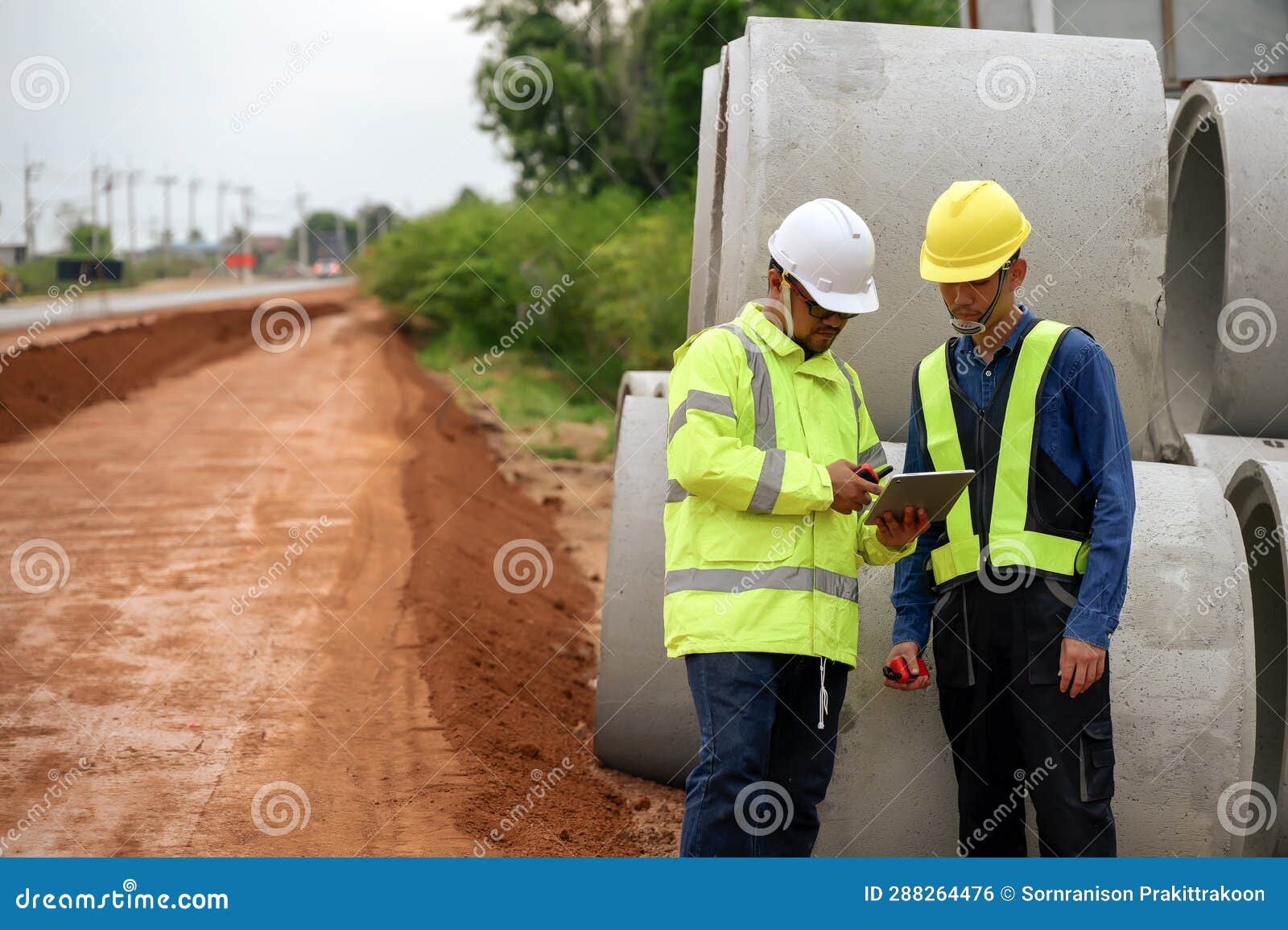Civil Engineers Discuss the Job with Construction Foreman while Using ...