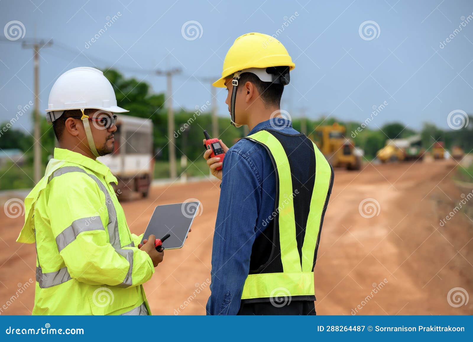 Civil Engineers Discuss the Job with Construction Foreman while Using ...